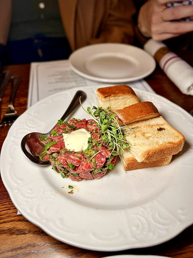Tartare that makes raw beef feel like a revelation rather than a risk. That dollop of creaminess is the culinary equivalent of a perfect punchline.