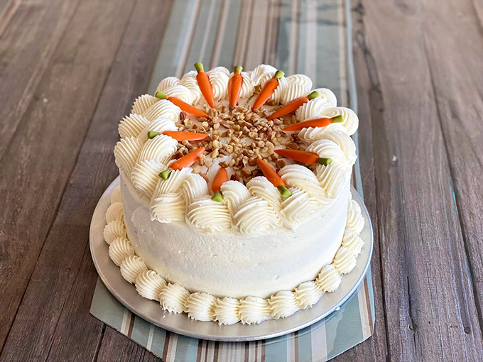 Behold the crown jewel—a carrot cake that makes other desserts feel like they need to try harder. Those perfectly piped rosettes aren't just showing off, they're justified.