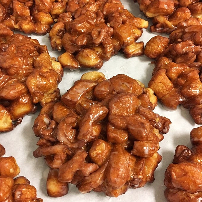 These apple fritters aren't just fried dough&mdash;they're architectural marvels of caramelized edges and tender centers. Each craggy surface captures glaze like nature's perfect design.