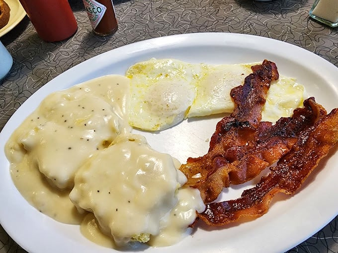 Biscuits smothered in country gravy alongside perfectly cooked eggs and bacon &ndash; the breakfast trinity that's been solving life's problems since time immemorial.