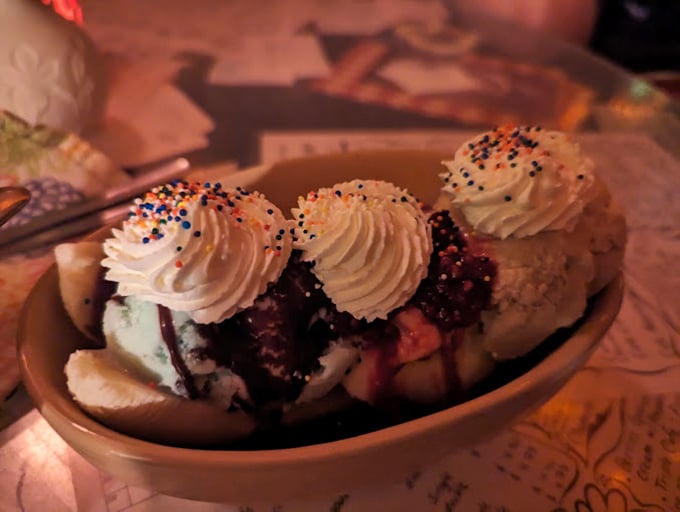 Whipped cream mountains atop colorful valleys of ice cream. This banana split isn't just dessert, it's architecture you can eat.