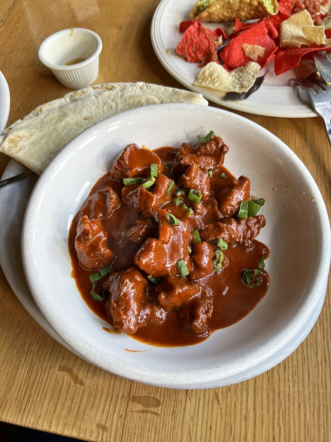Red chile beef tips that pack more flavor than a telenovela packs drama—served with a tortilla to ensure not a drop of sauce escapes.