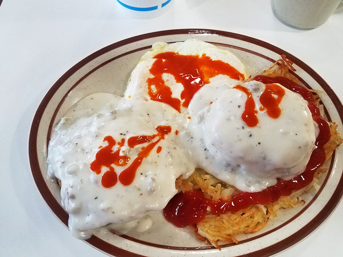 Breakfast paradise found: crispy hash browns crowned with sausage gravy and a splash of ketchup&mdash;proof that morning meals don't need to be complicated to be magnificent.