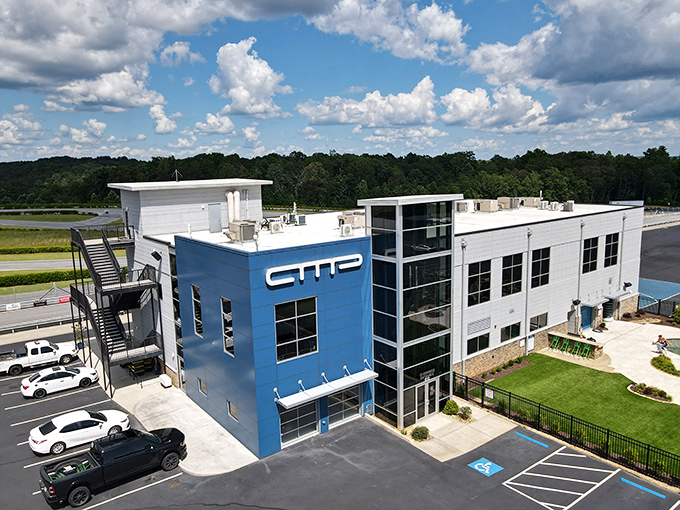The clubhouse at Atlanta Motorsports Park stands like a modern racing cathedral against Georgia's blue skies. Speed worshippers welcome.