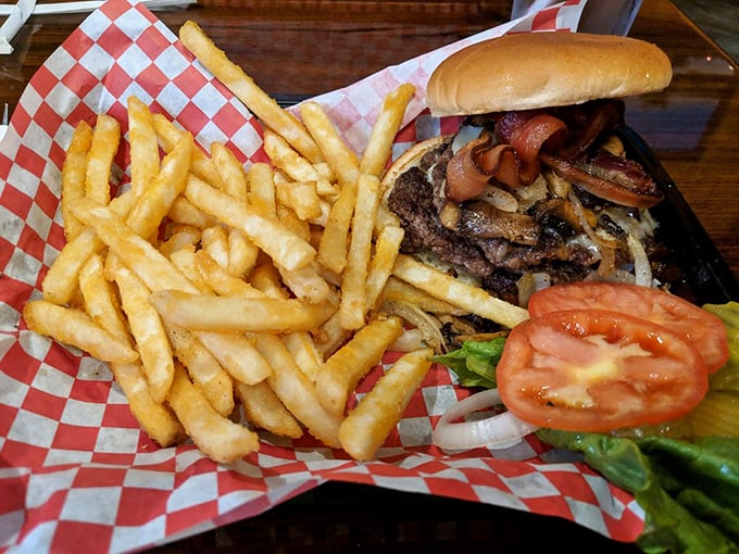 Burger architecture at its finest. The melted cheese forms a perfect seal with the patty, while golden fries stand at attention nearby.