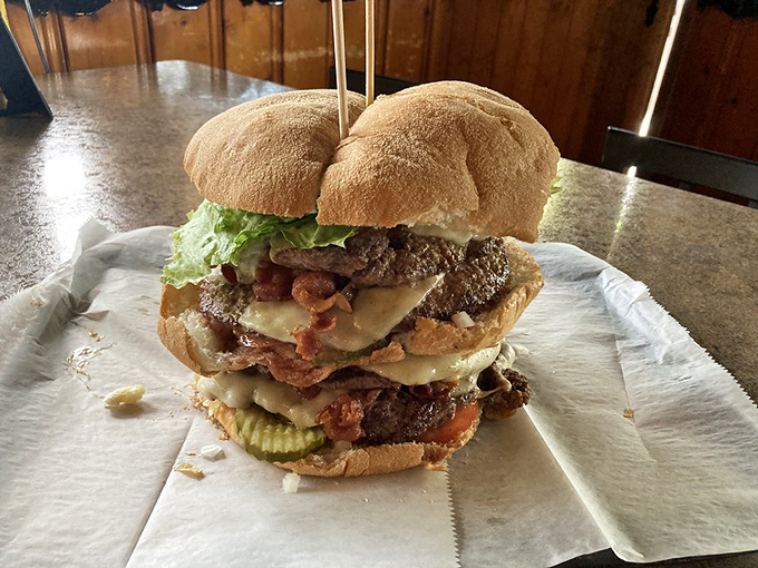 The burger, sliced in half, reveals its glorious inner workings. Like cutting into a geode, but instead of crystals, you find bacon and melted cheese.