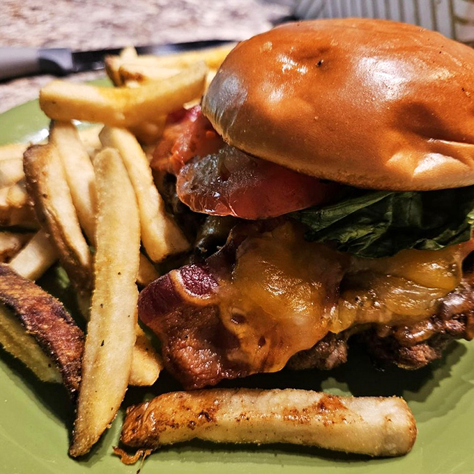 This isn't just a burger; it's architecture. The bacon hanging over the edges isn't sloppy—it's generosity you can taste.