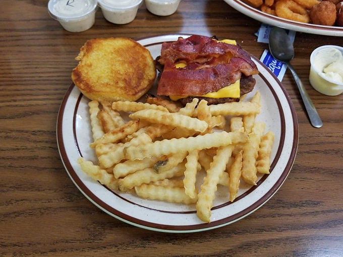 This isn't just a burger&mdash;it's a Midwestern handshake between perfectly grilled beef, melty cheese, and crispy bacon, with fries standing at attention nearby.