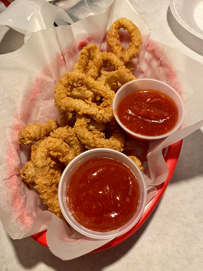 Golden rings of calamari that crunch louder than your neighbor's leaf blower. Two dipping sauces because life's too short for sauce monogamy.
