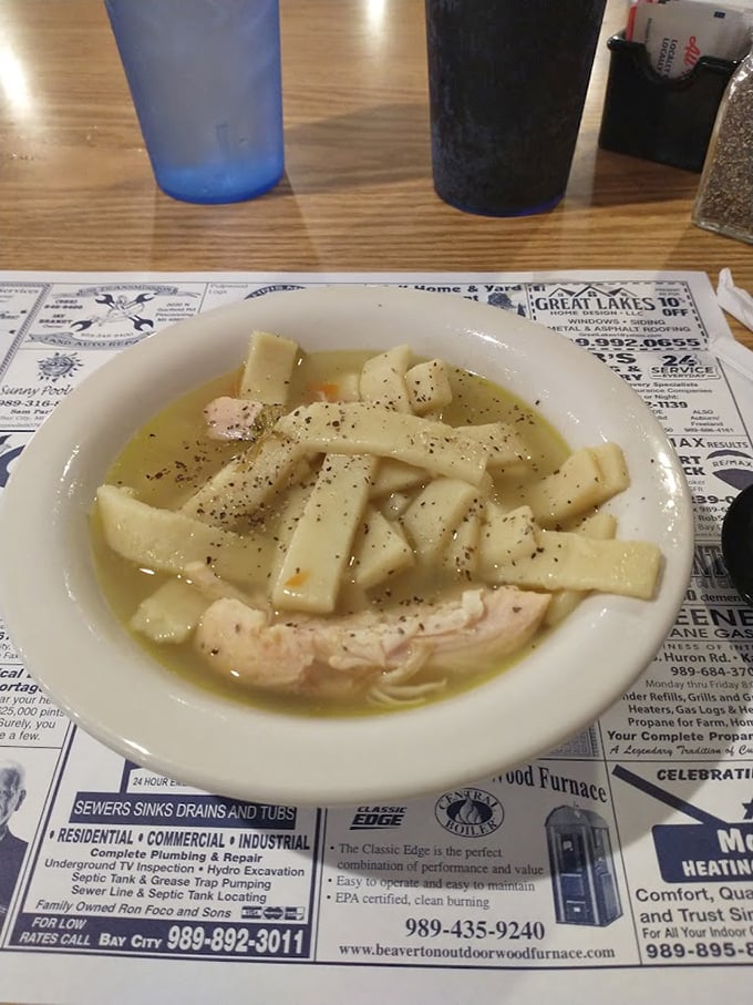 This chicken noodle soup isn't just food; it's liquid therapy, with hand-cut noodles swimming alongside tender chicken in a broth that tastes like childhood.