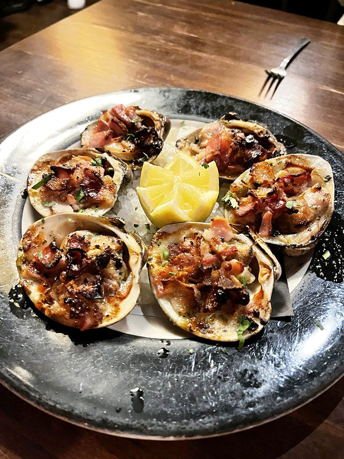 These clams aren't just topped with bacon&mdash;they're wearing little tuxedos made of it. Ocean and farm, having a delicious formal dance on your plate.