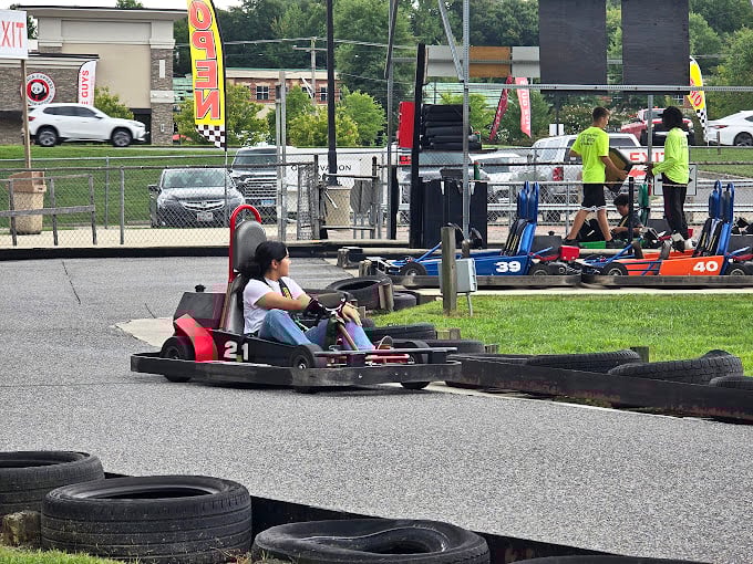 Mid-race concentration that rivals chess grandmasters. Notice the white-knuckle grip &ndash; that's the universal sign of someone discovering their competitive spirit.