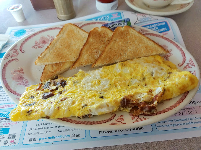 Mounds of hash browns that'd make Ron Swanson tear up with joy – crispy, golden potato perfection on a no-nonsense white plate.