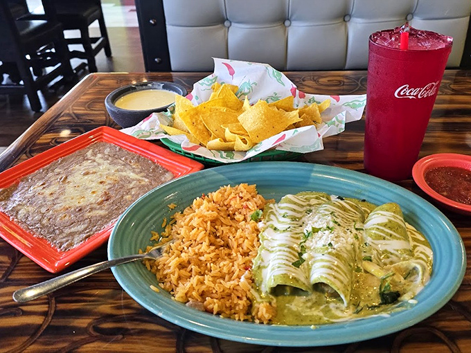 Green enchiladas dressed for success on a turquoise plate. The rice didn't come to play either&mdash;it came to slay your hunger.