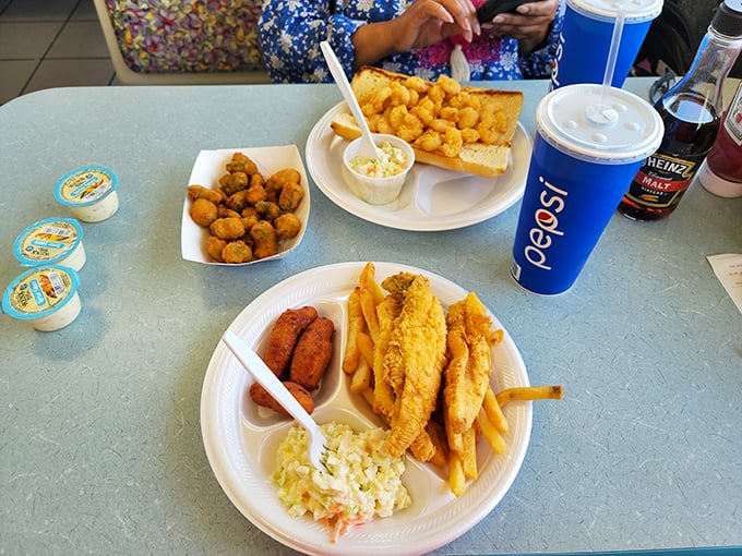 The holy trinity of Southern comfort: perfectly fried fish, french fries, and those addictive little hushpuppies that disappear faster than your willpower.