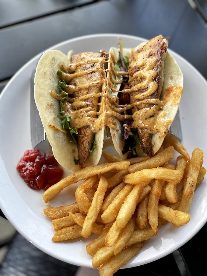 These aren't just fish tacos; they're vacation memories wrapped in a tortilla. Crispy, saucy perfection with fries that clearly graduated with honors.
