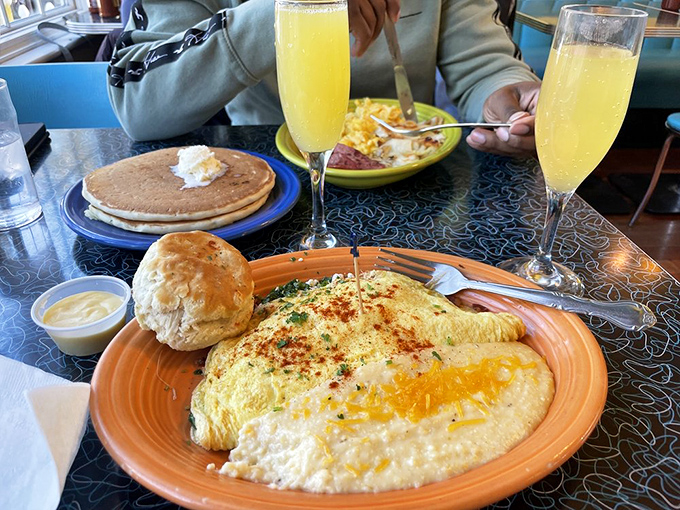 Breakfast diplomacy at its finest&mdash;a Florentine omelet sharing a plate with cheesy grits and a biscuit. The United Nations should take notes on this peaceful coexistence.
