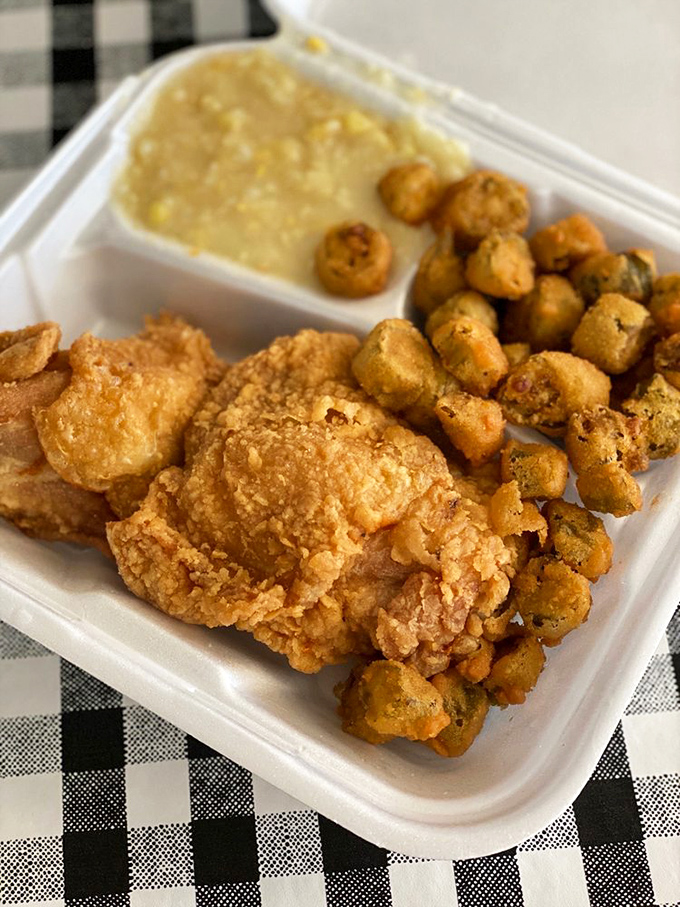 Golden-fried chicken with a crunch you can hear across the room, paired with okra and creamy grits that whisper "welcome home."