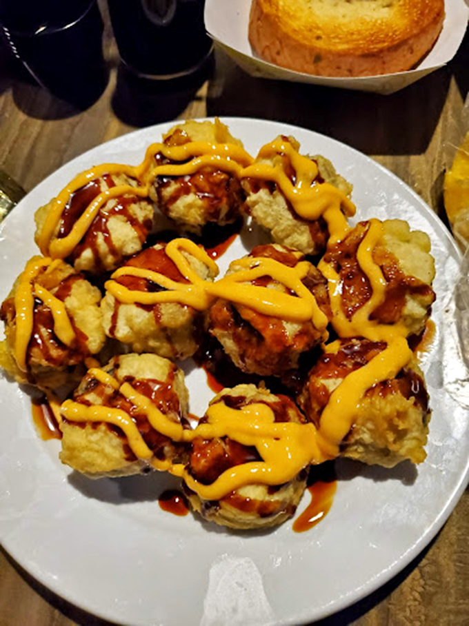 What looks like crispy golden clouds are actually Bang Bang shrimp&mdash;crunchy, saucy little flavor bombs that disappear faster than your resolution to share.