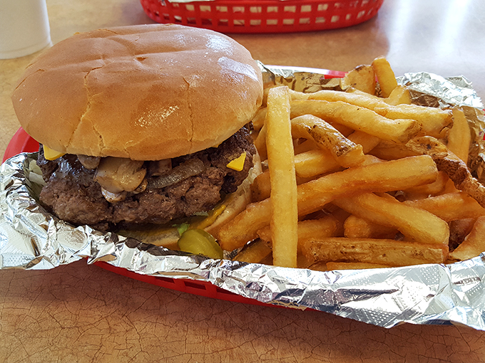 Golden fries nestled beside a burger that's clearly the star of the show&mdash;a dynamic duo of roadside perfection.