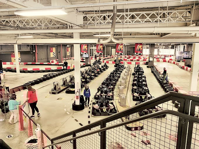 From this bird's-eye view, the track resembles a mechanical ballet, with karts dancing their high-speed choreography below.