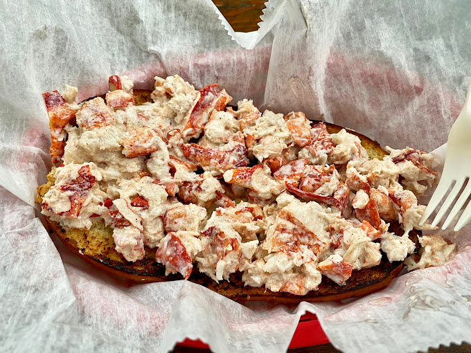 This isn't just a lobster roll; it's edible evidence that sometimes the simplest pleasures deliver the most profound satisfaction.