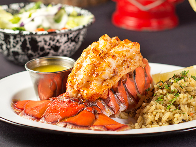 Lobster tail perched atop its shell like royalty surveying its kingdom of rice pilaf. The butter sauce? That's liquid gold, my friends.