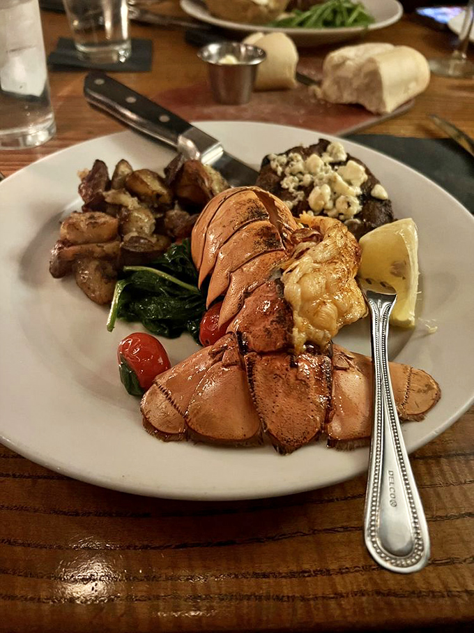 This lobster tail isn't just dinner, it's maritime royalty on vacation in Missouri. The steak beside it seems to understand its supporting role.