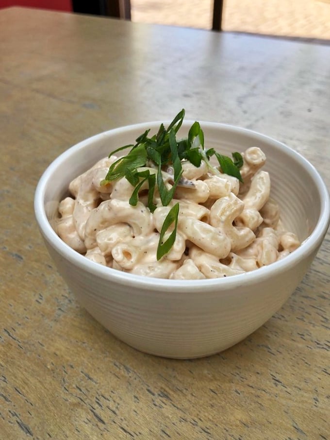 Mac salad that doesn't apologize for being comfort food. Those green onions aren't just garnish &ndash; they're the bow on a creamy, nostalgic gift.