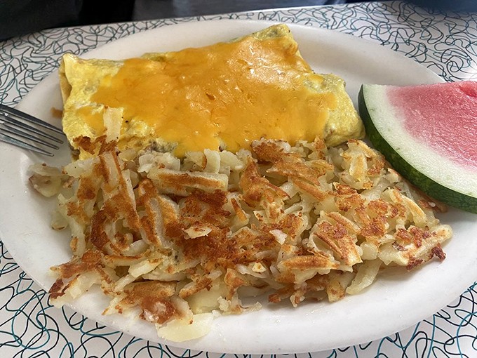 The perfect omelet-hash brown relationship: one brings the fluffy cheese-filled goodness, the other brings the crispy, golden support. That's partnership.