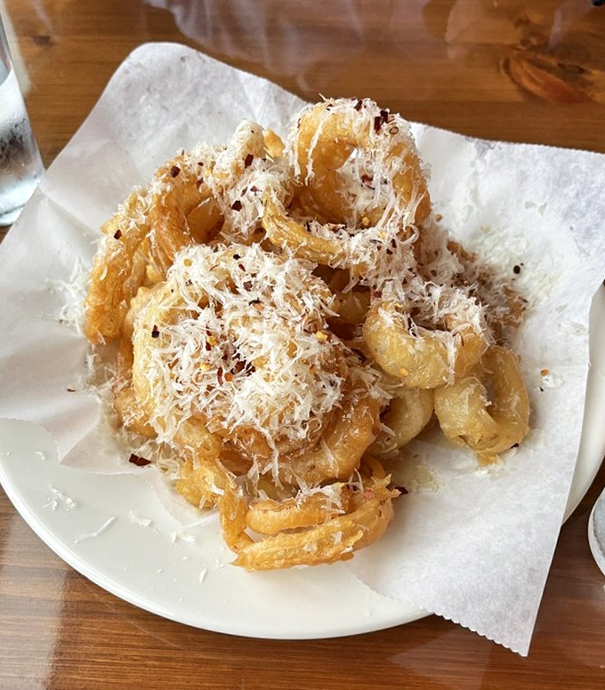 These aren't your average onion rings&mdash;they're crispy, golden halos dusted with parmesan that deserve their own fan club.