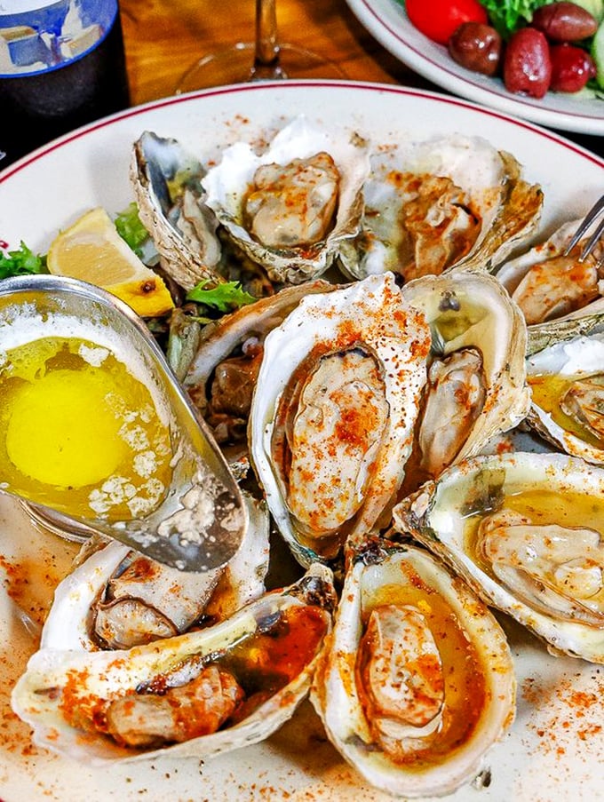 These oysters aren't just seafood; they're little saline treasures from the Chesapeake Bay, dressed with just enough spice to make them sing without drowning out their natural melody.