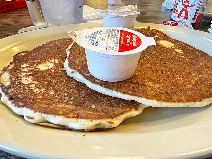 These pancakes aren't just breakfast, they're edible therapy &ndash; golden-brown, plate-sized, and waiting patiently for their maple bath.