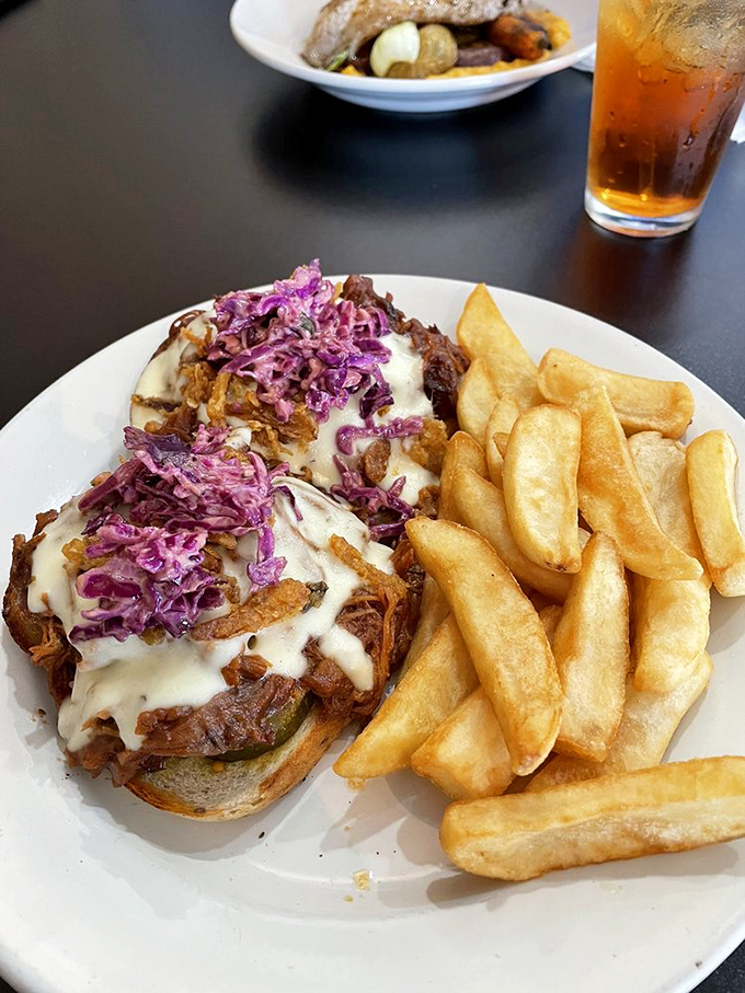 Not your average sandwich! This pulled pork creation topped with purple slaw is what happens when comfort food gets dressed up for a night out.