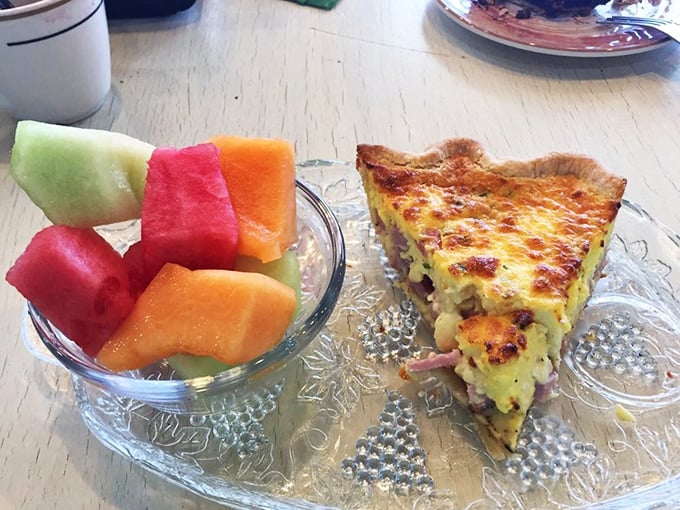 Savory meets spectacular in this quiche slice. The fruit cup is there to make you feel virtuous, but we know why you came.