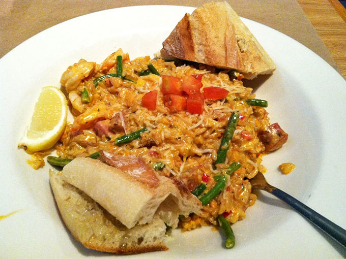 This creamy seafood risotto, studded with green beans and tomatoes, is comfort food that somehow traveled from an Italian coastal village to Omaha.