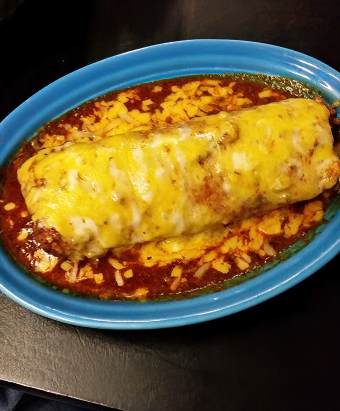 This burrito didn't just get dressed—it got completely smothered in a sauce so good you'll be tempted to lick the plate.