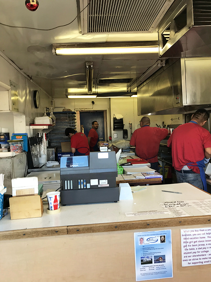 The kitchen crew moves with the choreographed precision of people who know that burger-making isn't just a job, it's a calling.