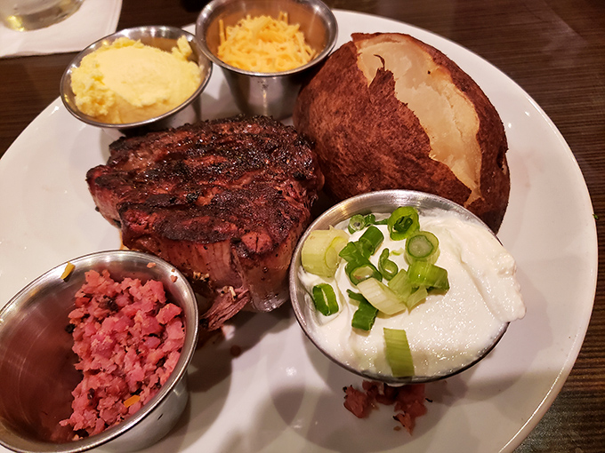 Loaded baked potato, sour cream, cheese, and a steak cooked to ruby perfection&mdash;this is what carnivorous dreams are made of.