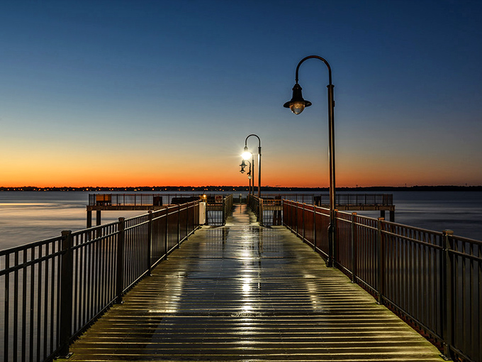 The pier at sunset transforms into a runway of light and shadow&mdash;nature's way of saying "I can upstage your historic buildings anytime."