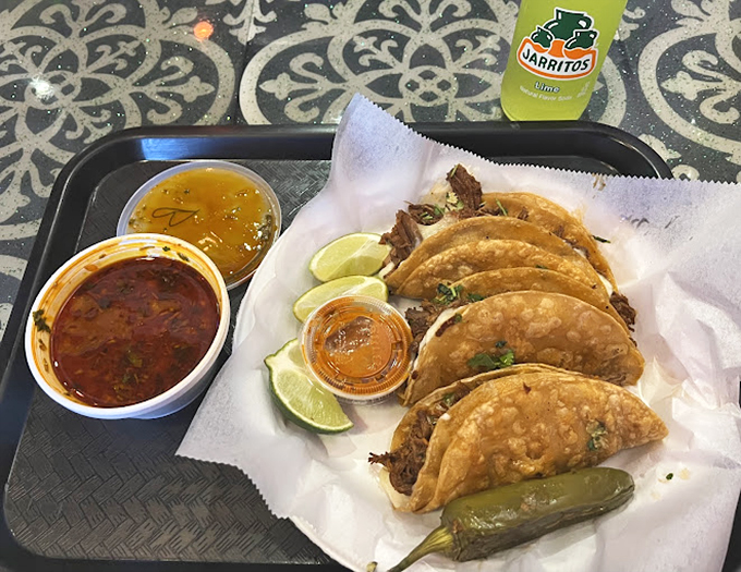 Taco perfection: crispy shells, tender meat, fresh lime wedges, and those essential dipping sauces. The roasted jalape&ntilde;o is the exclamation point on this flavor sentence.