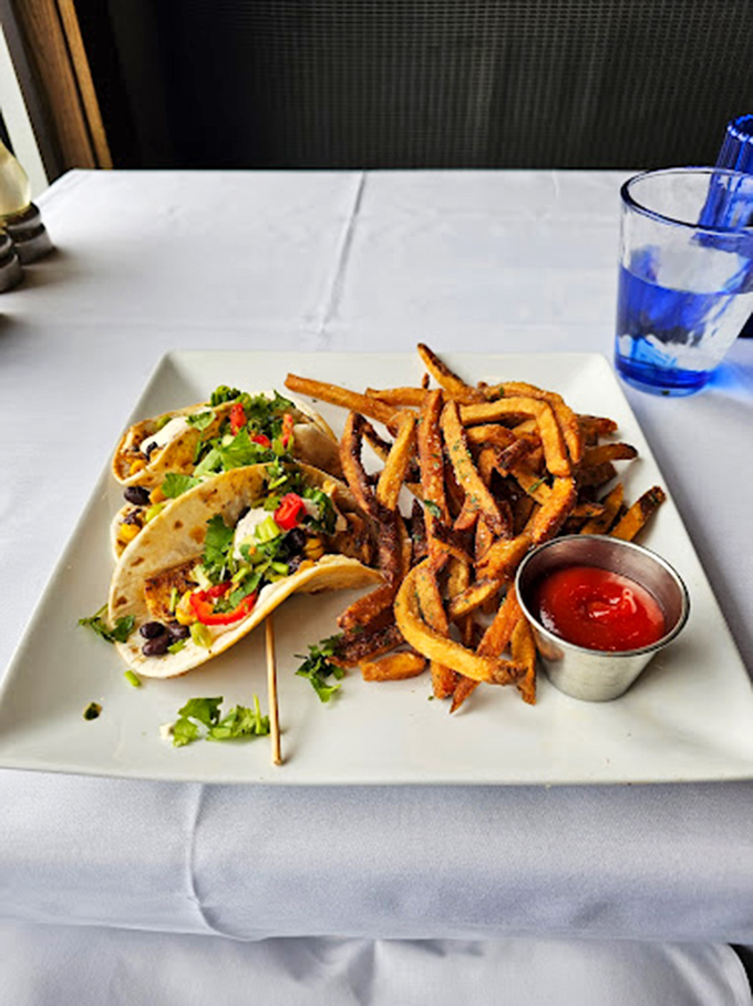 The lobster roll&mdash;a buttery, toasted vessel cradling sweet chunks of lobster. A pickle stands guard, though it's an unnecessary precaution&mdash;no one's sharing this. 