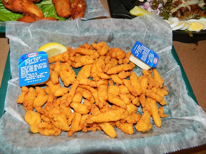 The holy trinity of seafood dining: perfectly fried clams, a wedge of lemon, and tartar sauce that deserves its own fan club.