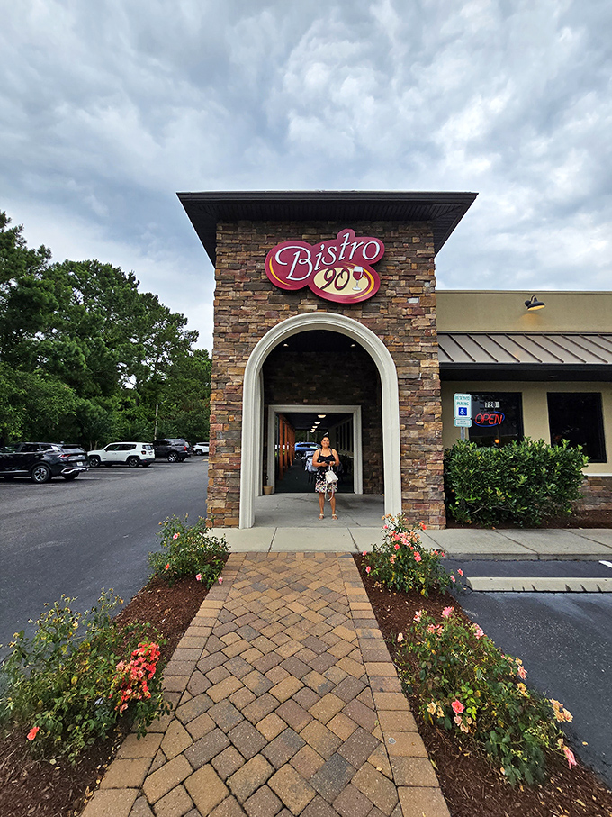 Bistro 90's stone archway entrance feels like a portal to flavor country. The roses are just a preview of the beauty inside.
