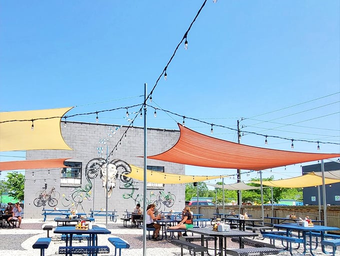 Half Liter's outdoor oasis with colorful shade sails creates a backyard BBQ vibe that makes every day feel like a summer holiday.