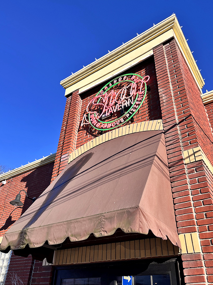 Star Tavern's neon glow against brick is the bat signal for bar pie enthusiasts. The quest for crispy edges ends here.