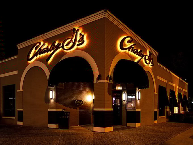 Arches by night, grilled perfection by dinner. Charley G's landmark facade signals "exceptional meal ahead."