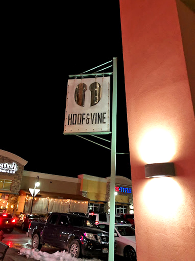 Night lights, meat heights. Hoof & Vine's illuminated sign serves as a beacon for those seeking serious steak satisfaction.