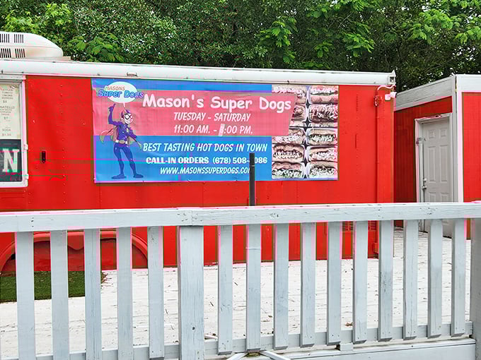 The red trailer with white picket fence feels like stumbling upon a hot dog carnival&mdash;complete with superhero logo that isn't overselling the experience.