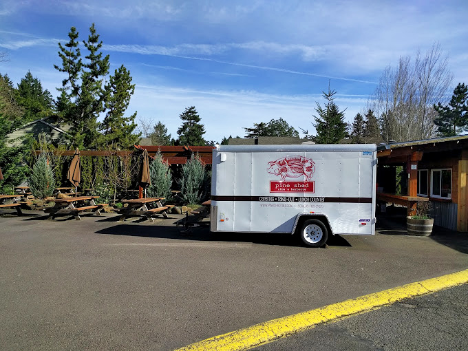 Blue tablecloths and picnic tables under trees - Pine Shed creates the backyard barbecue you wish your neighbor would host.